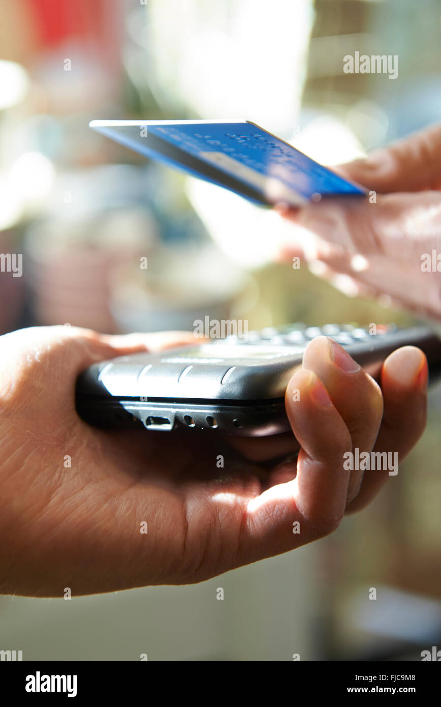 Customer Making Purchase Using Contactless Payment Stock Photo - Alamy