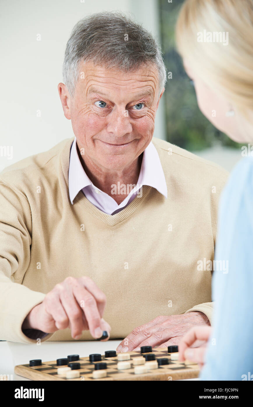 Senior Man Playing Checkers With Teenage Daughter Stock Photo - Alamy