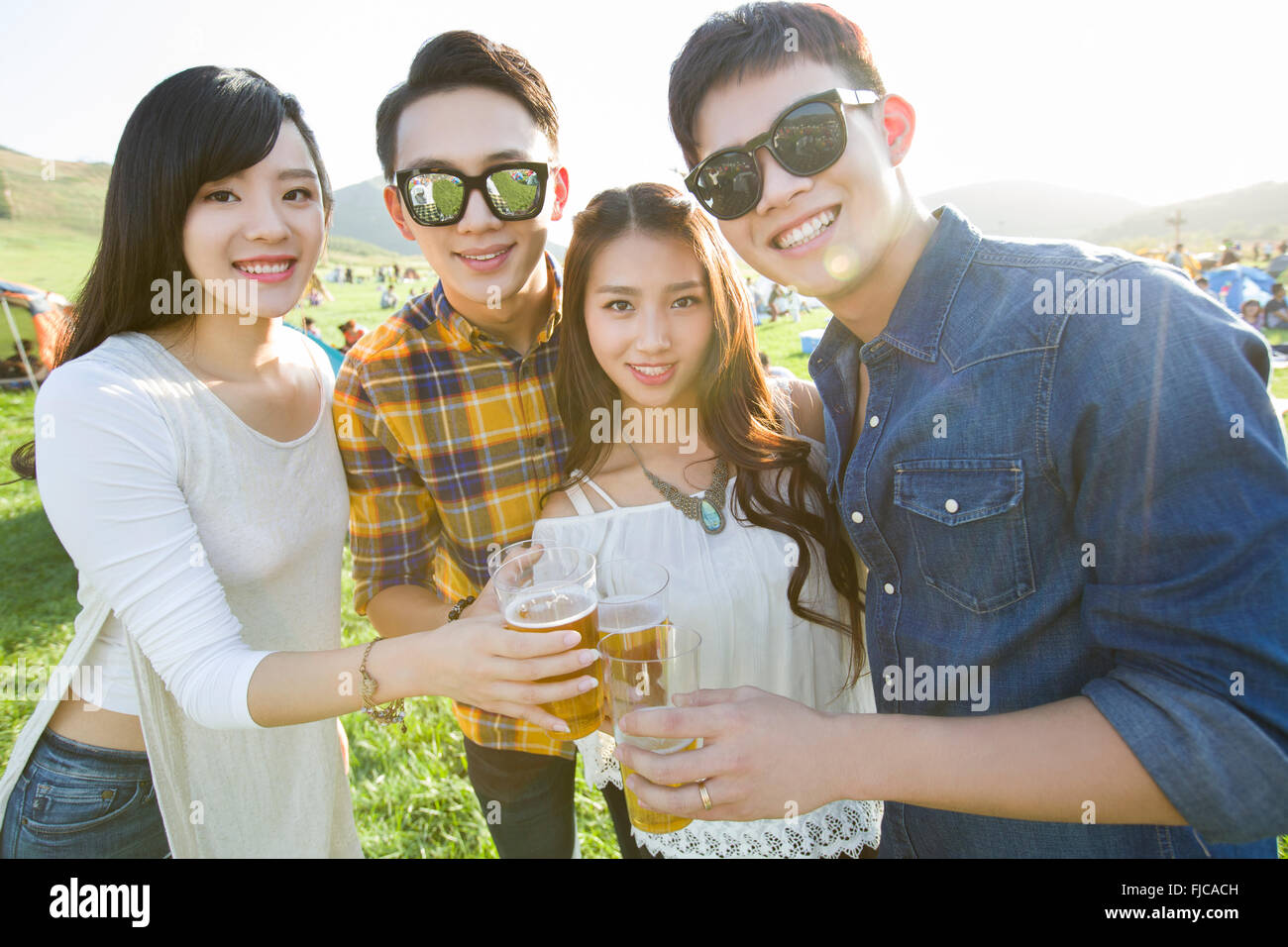 Happy Chinese friends drinking beer together Stock Photo - Alamy