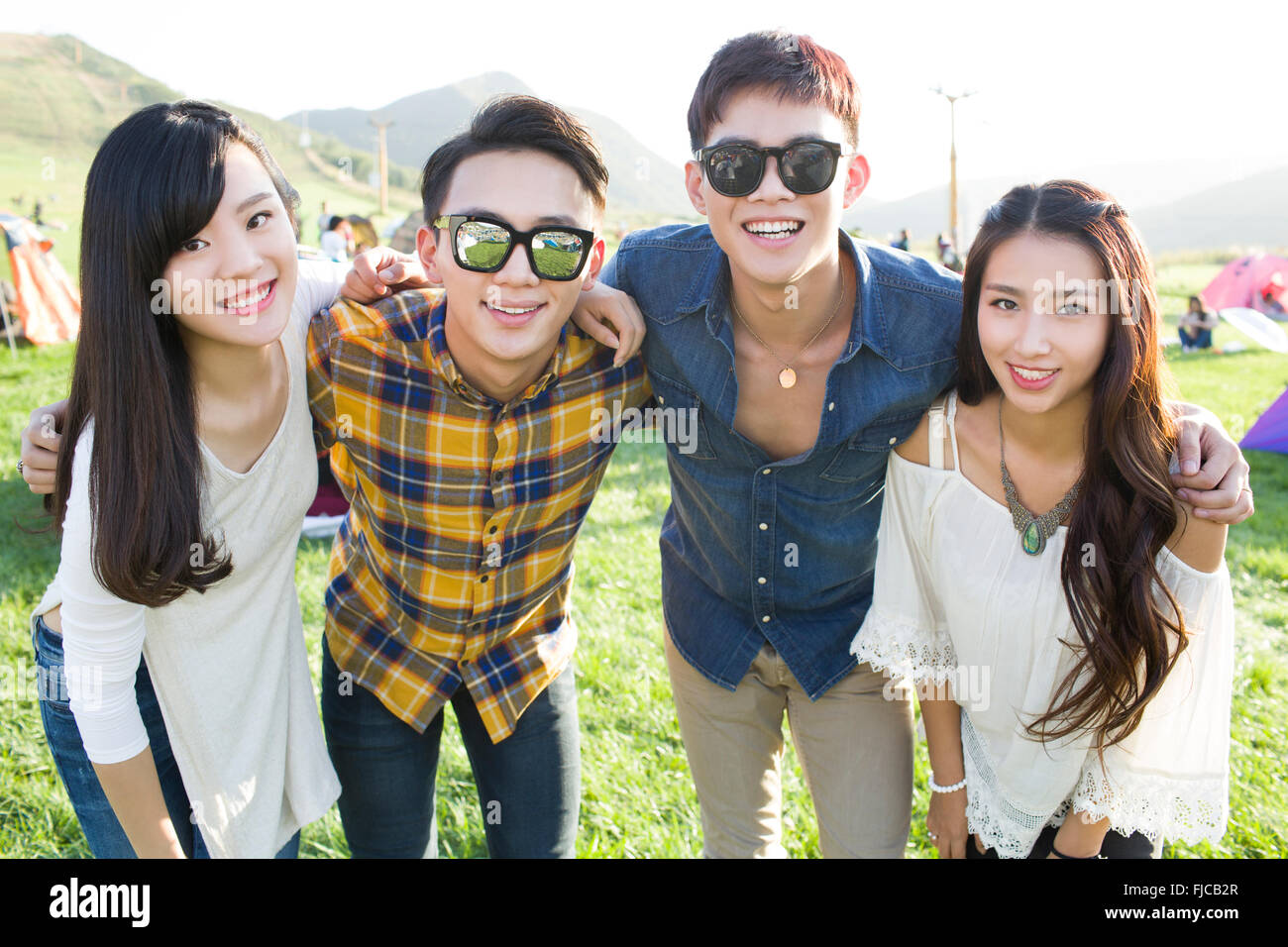 Happy Chinese friends at music festival Stock Photo - Alamy