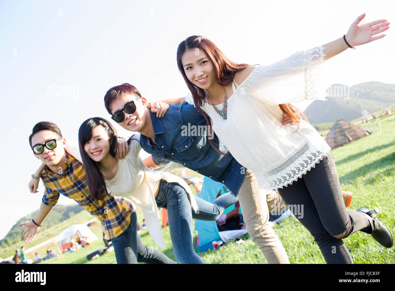 Happy Chinese friends at music festival Stock Photo - Alamy