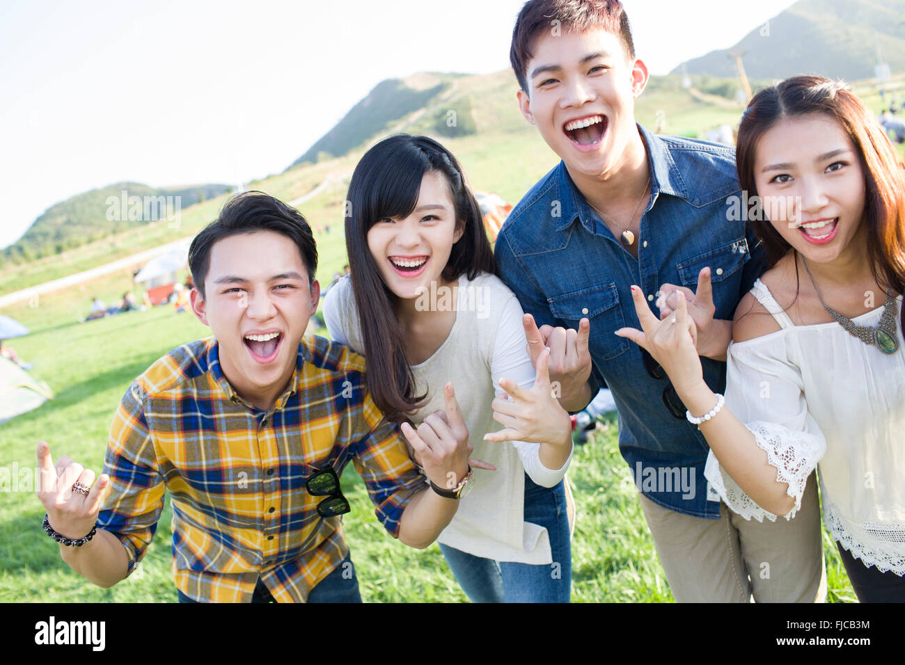 Happy Chinese friends at music festival Stock Photo - Alamy