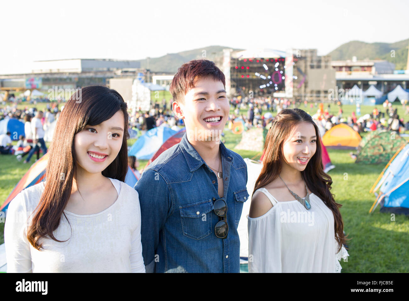 Happy Chinese friends at music festival Stock Photo - Alamy