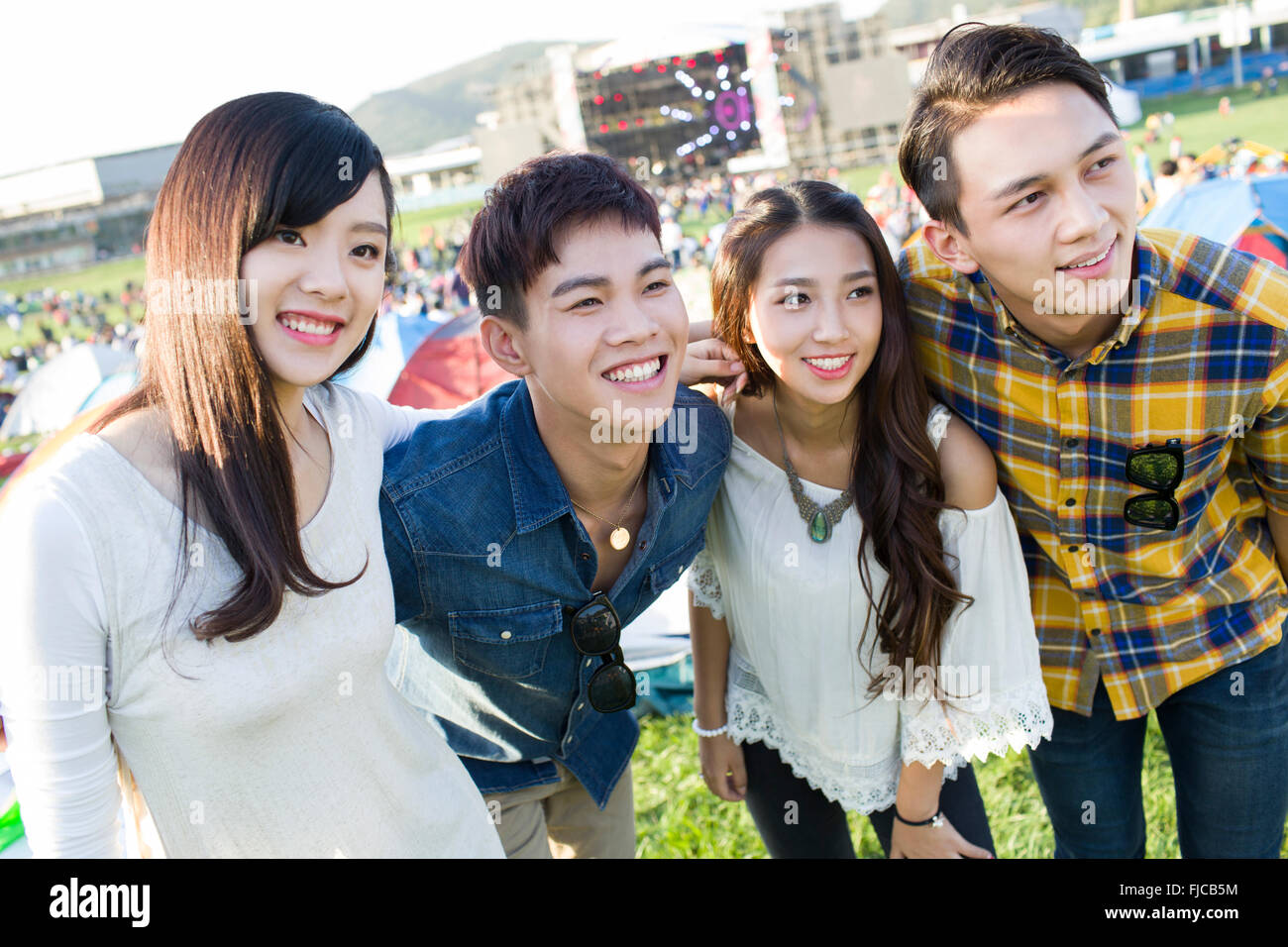 Happy Chinese friends at music festival Stock Photo - Alamy