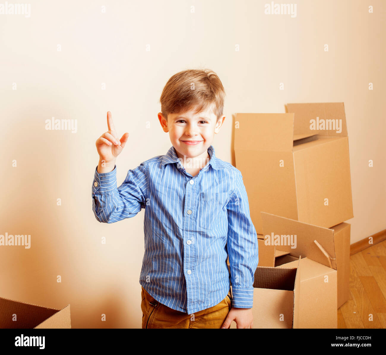 little cute boy in empty room, remoove to new house. home alone emong ...
