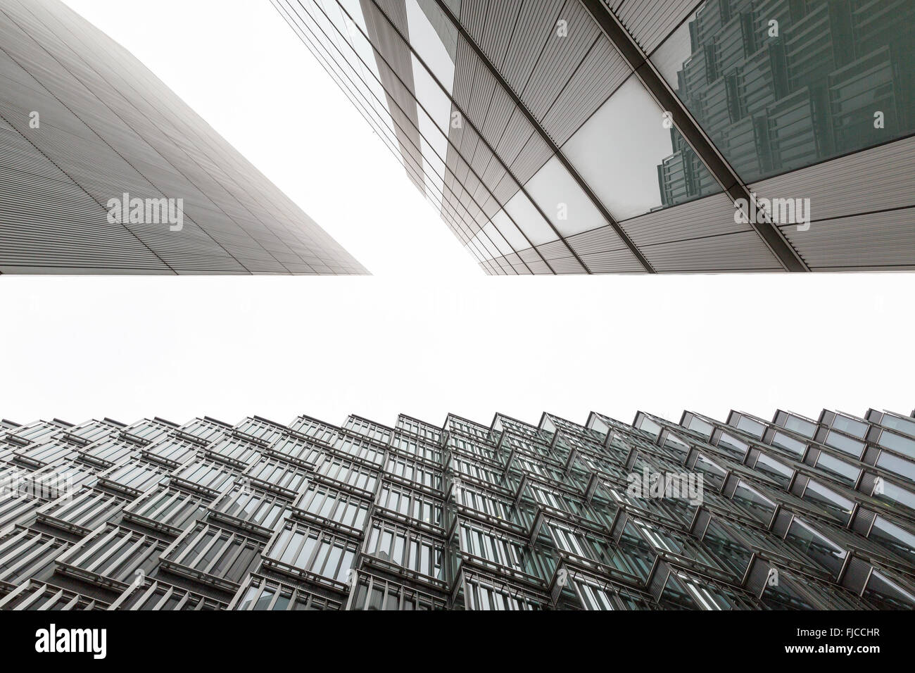 A coloured photo looking up capturing three different buildings on a ...