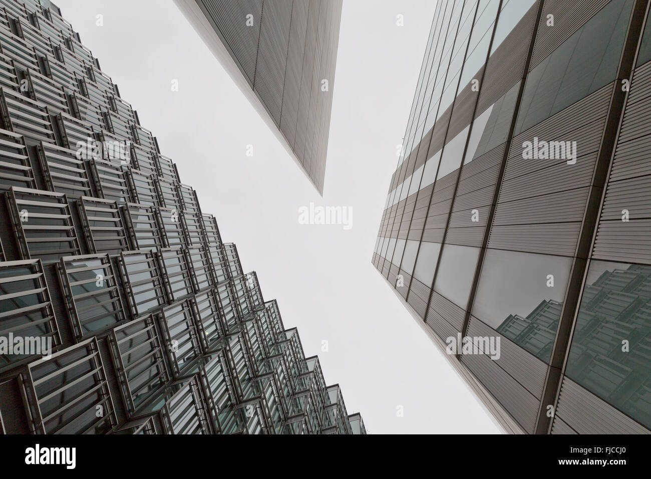 A coloured photo looking up capturing three different buildings on a ...