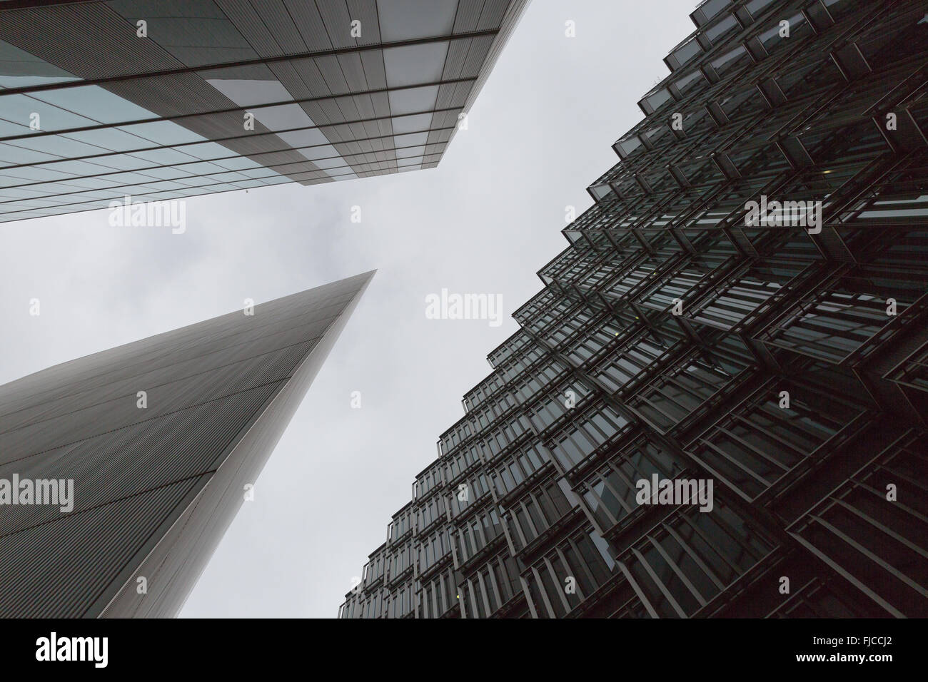 A coloured photo looking up capturing three different buildings on a ...