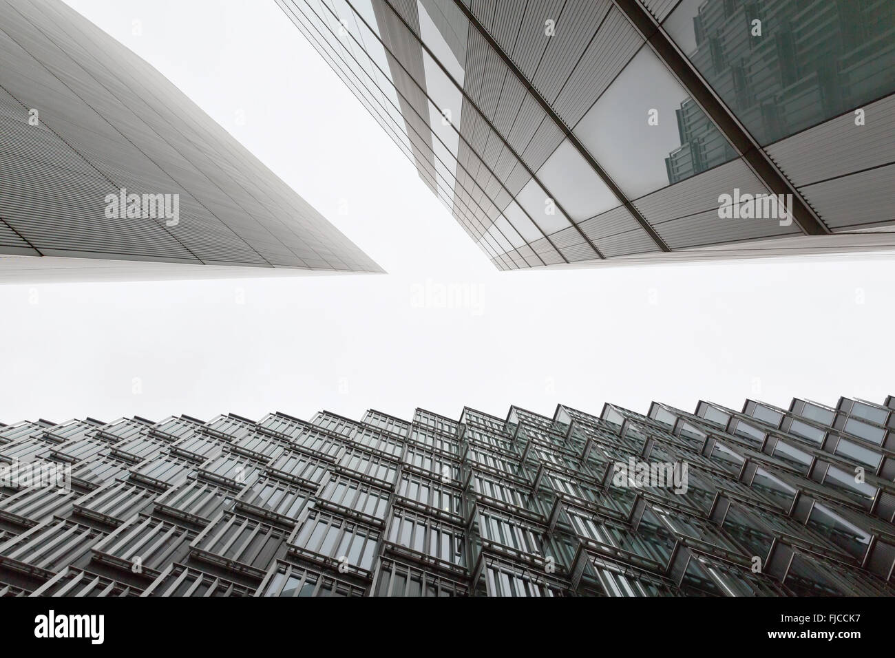 A photo looking up capturing three different buildings on an angle on a ...