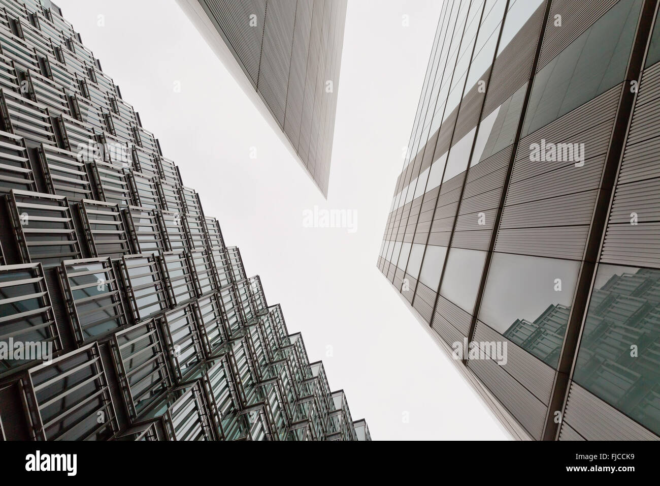 A photo looking up capturing three different buildings on an angle on a ...