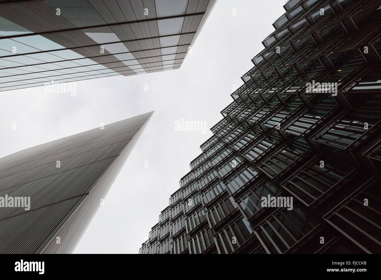 A photo looking up capturing three different buildings on an angle on a ...