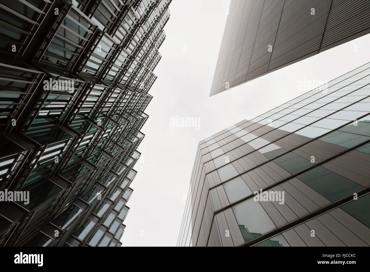 A photo looking up capturing three different buildings on an angle on a ...