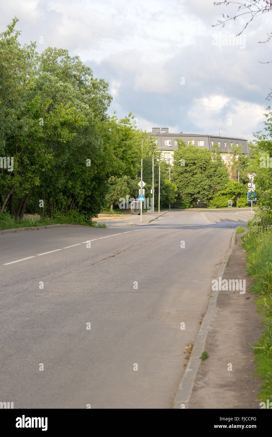 quiet street surrounded by trees of a park Stock Photo - Alamy