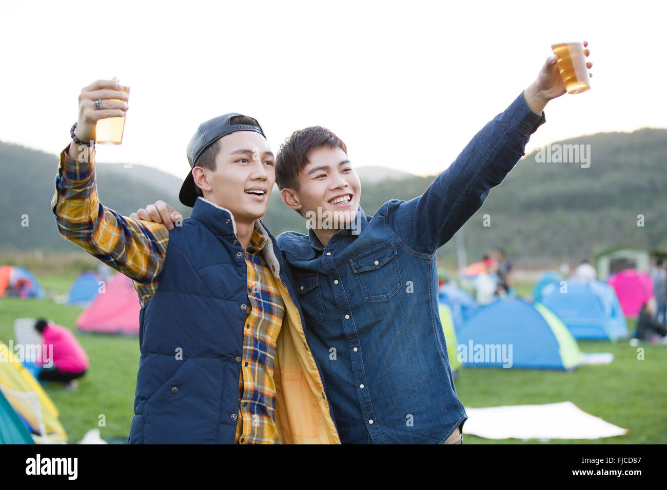 Happy Chinese friends drinking beer together Stock Photo - Alamy