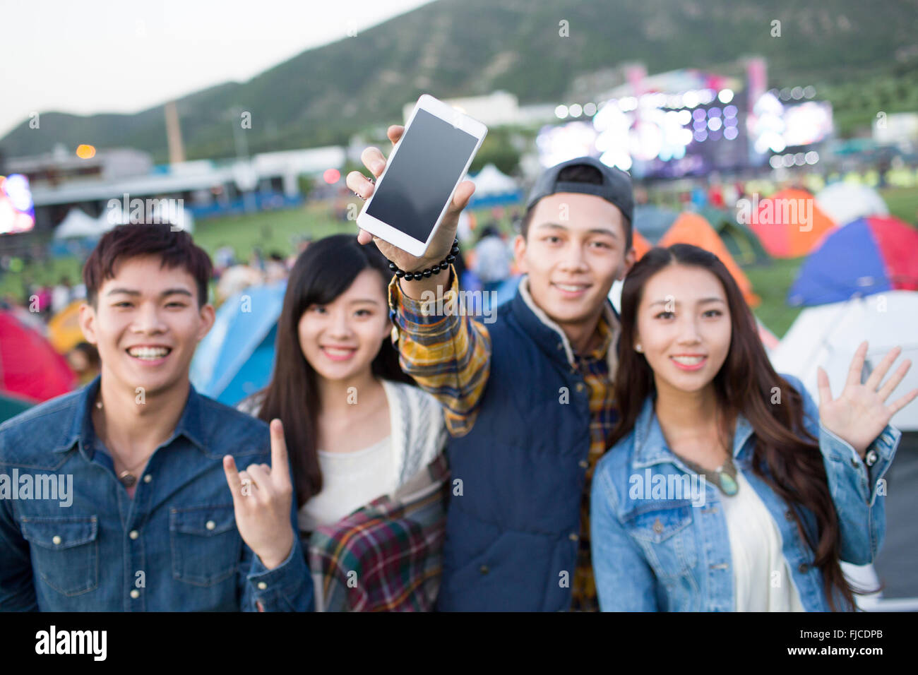 Happy Chinese friends showing a smart phone Stock Photo - Alamy