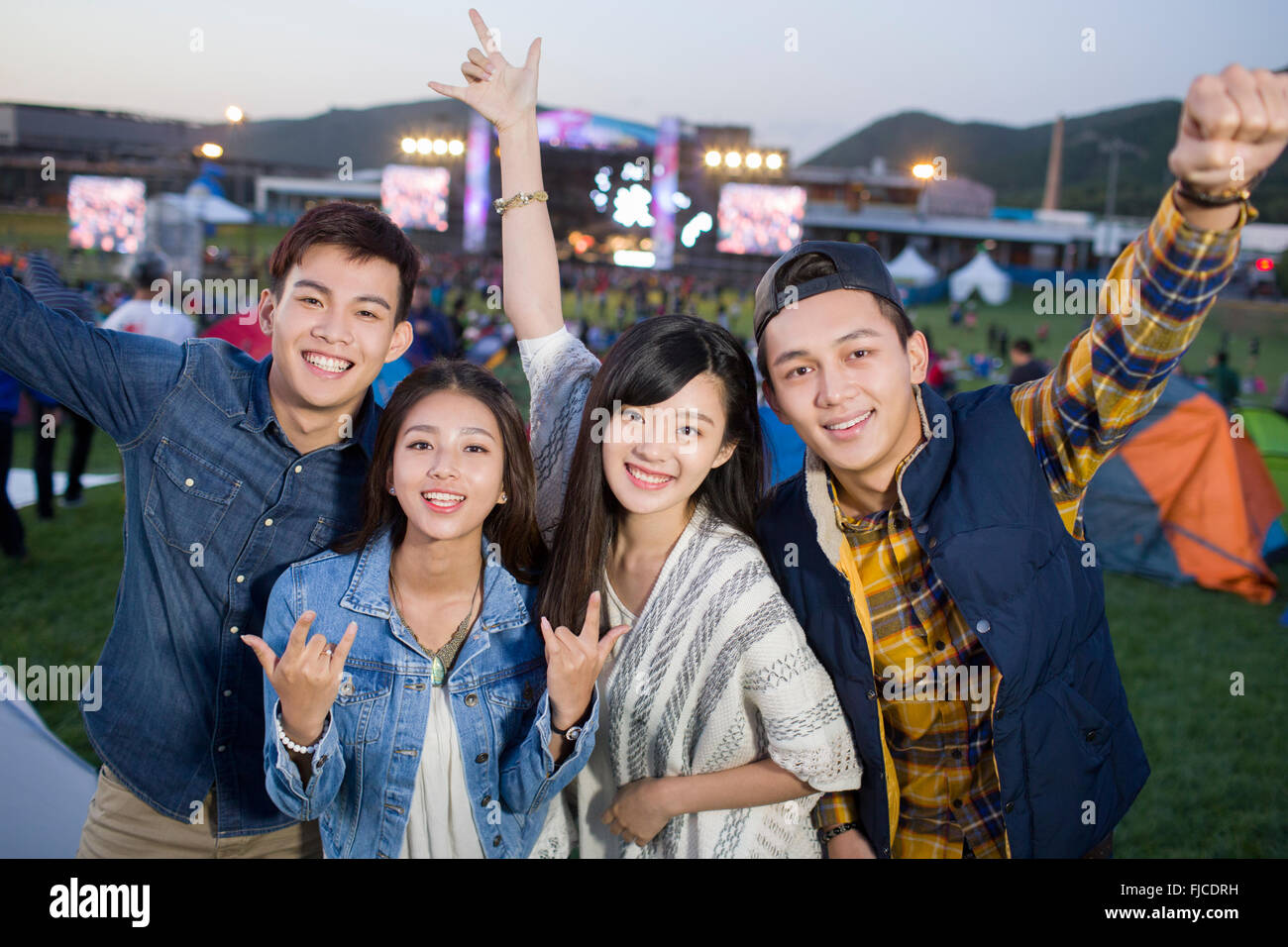 Happy Chinese friends at music festival Stock Photo - Alamy