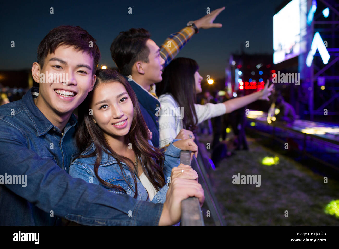 Happy Chinese friends at music festival Stock Photo - Alamy