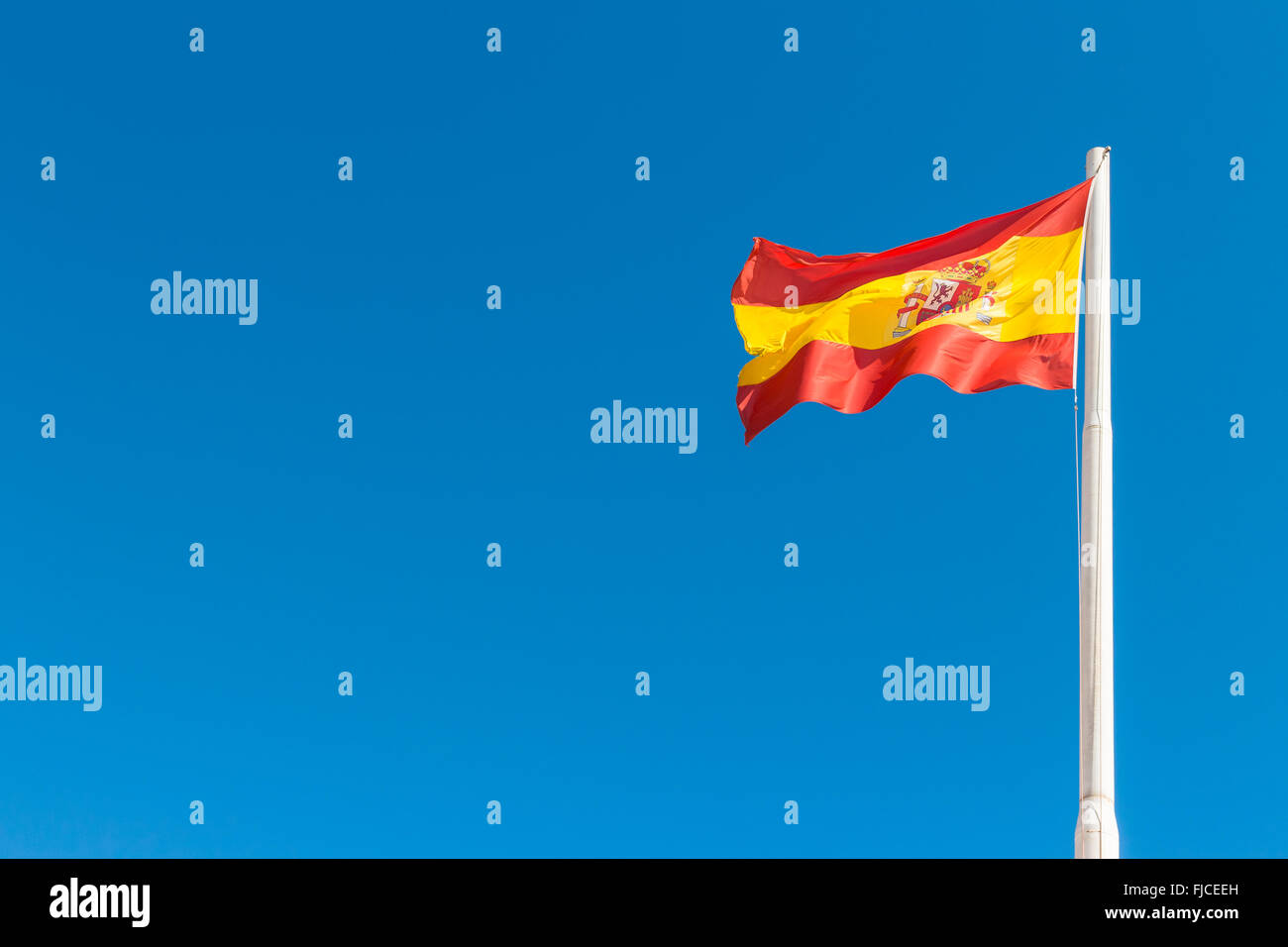 Spanish flag waving in the blue sky. Flag of Spain Stock Photo - Alamy