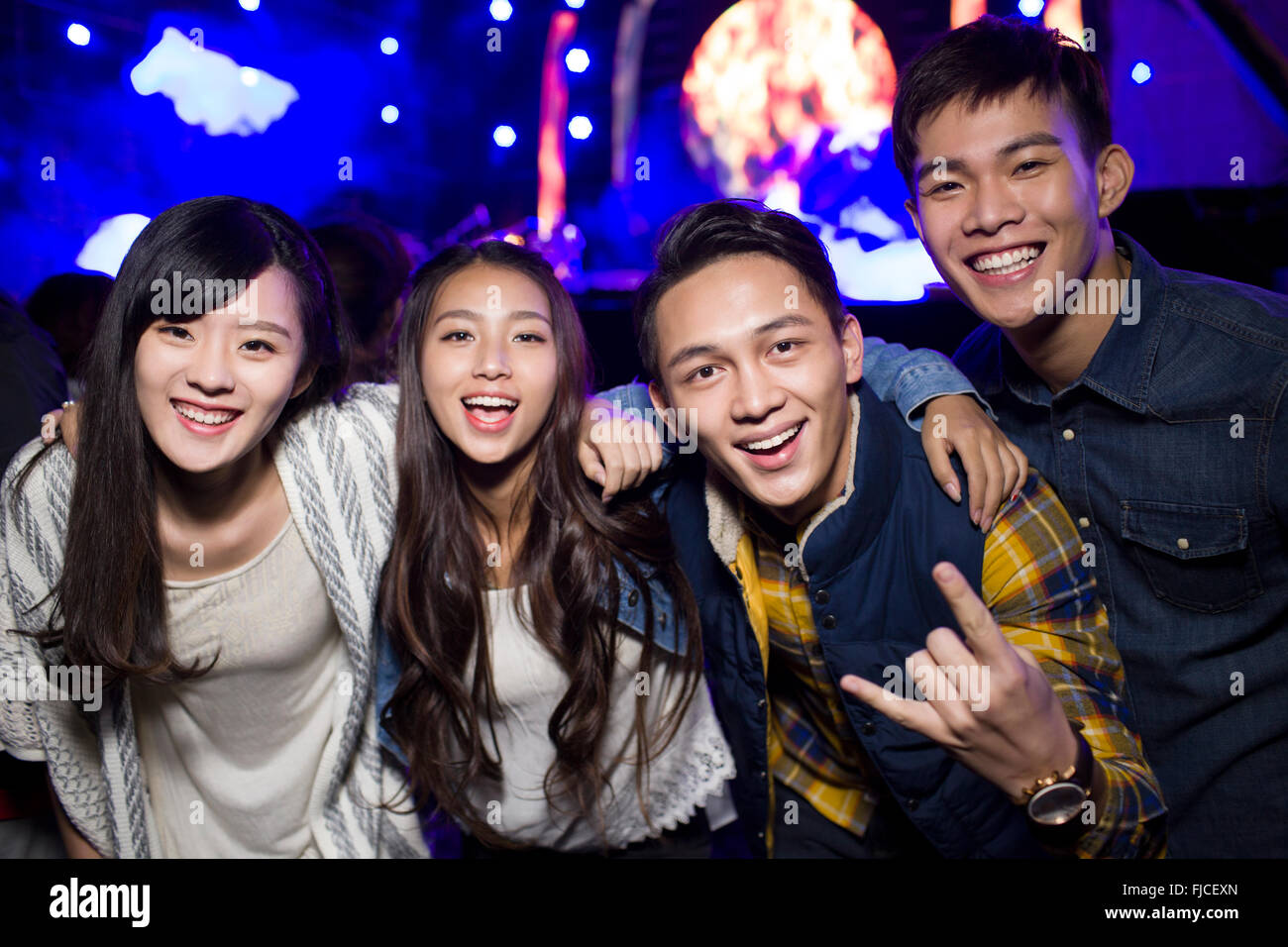 Happy Chinese friends at music festival Stock Photo - Alamy