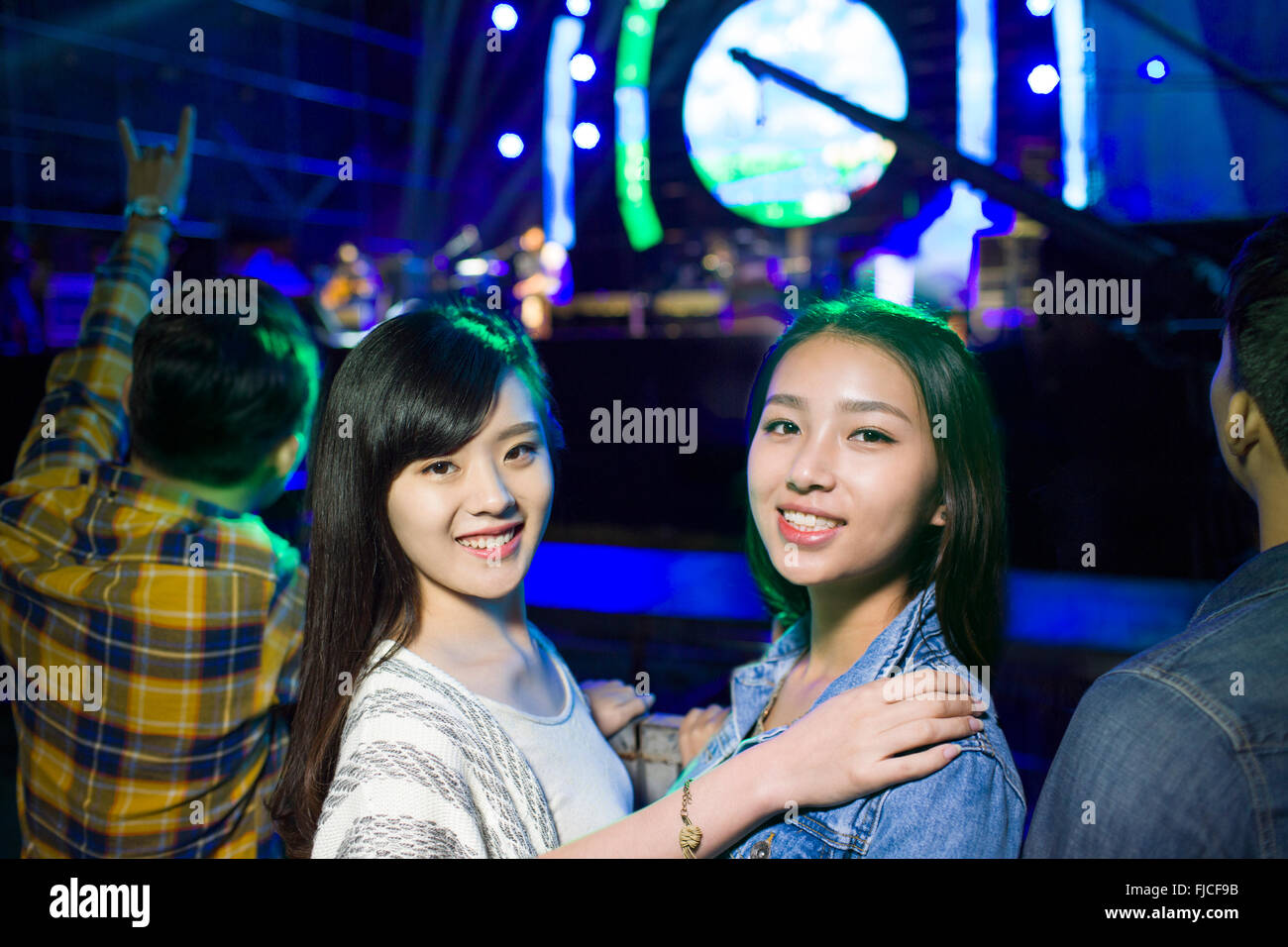 Happy Chinese friends at music festival Stock Photo - Alamy