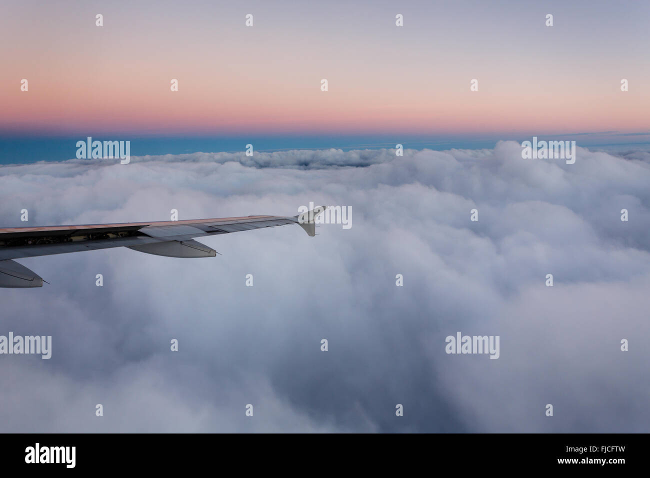 Sunset viewed from airplane above clouds Stock Photo - Alamy