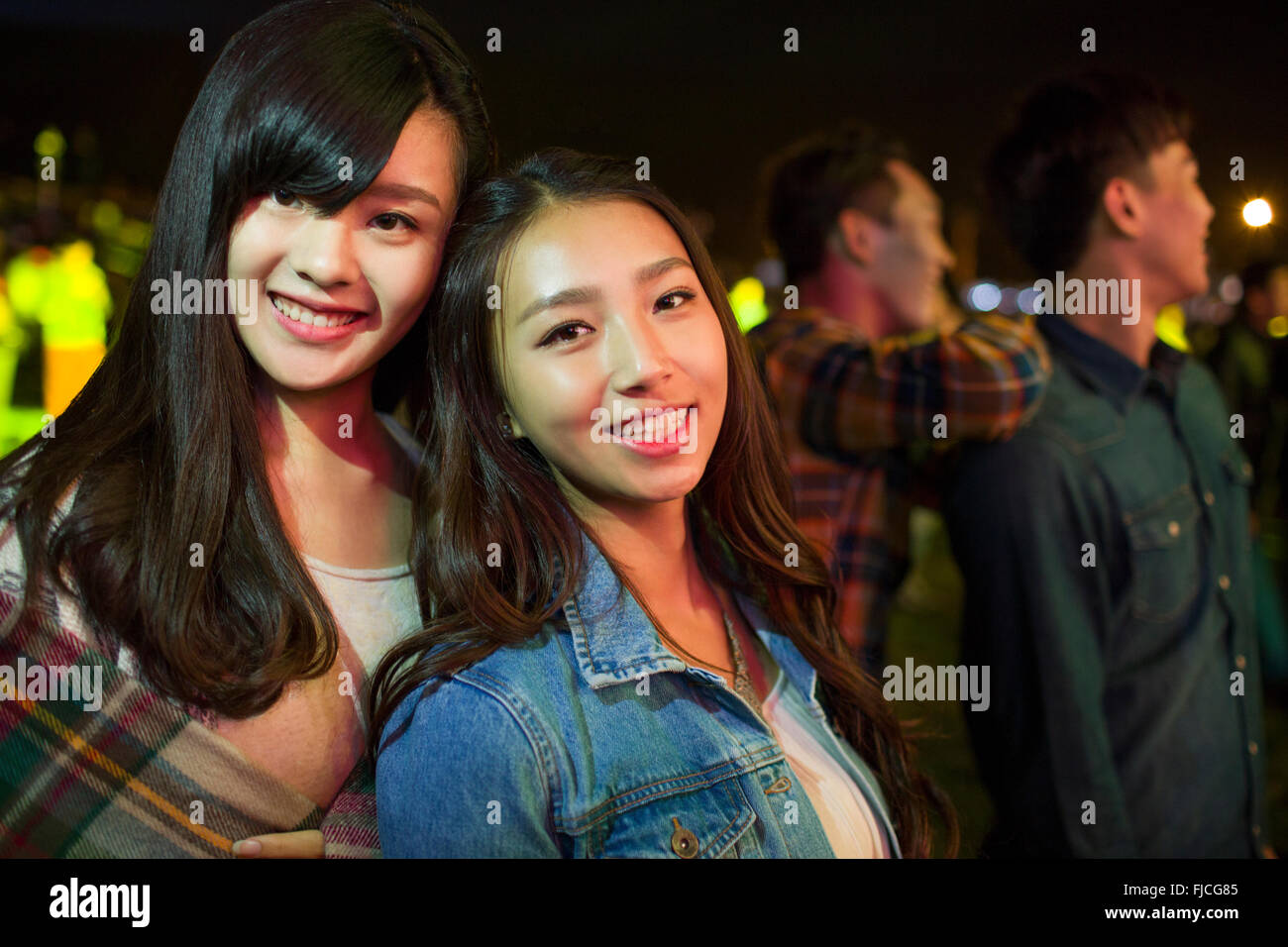 Happy young Chinese women at music festival Stock Photo - Alamy