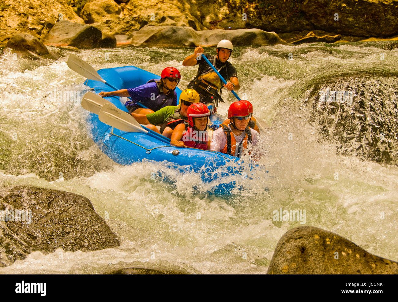 People whitewater rafting through wild rapids of the Lower Pacuare ...