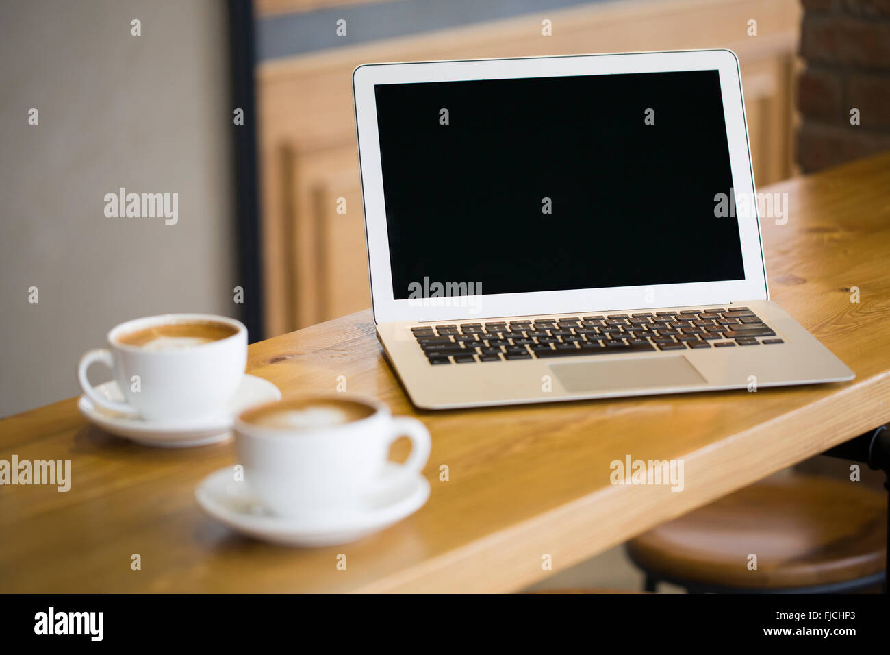 Coffee and laptop on the table Stock Photo - Alamy
