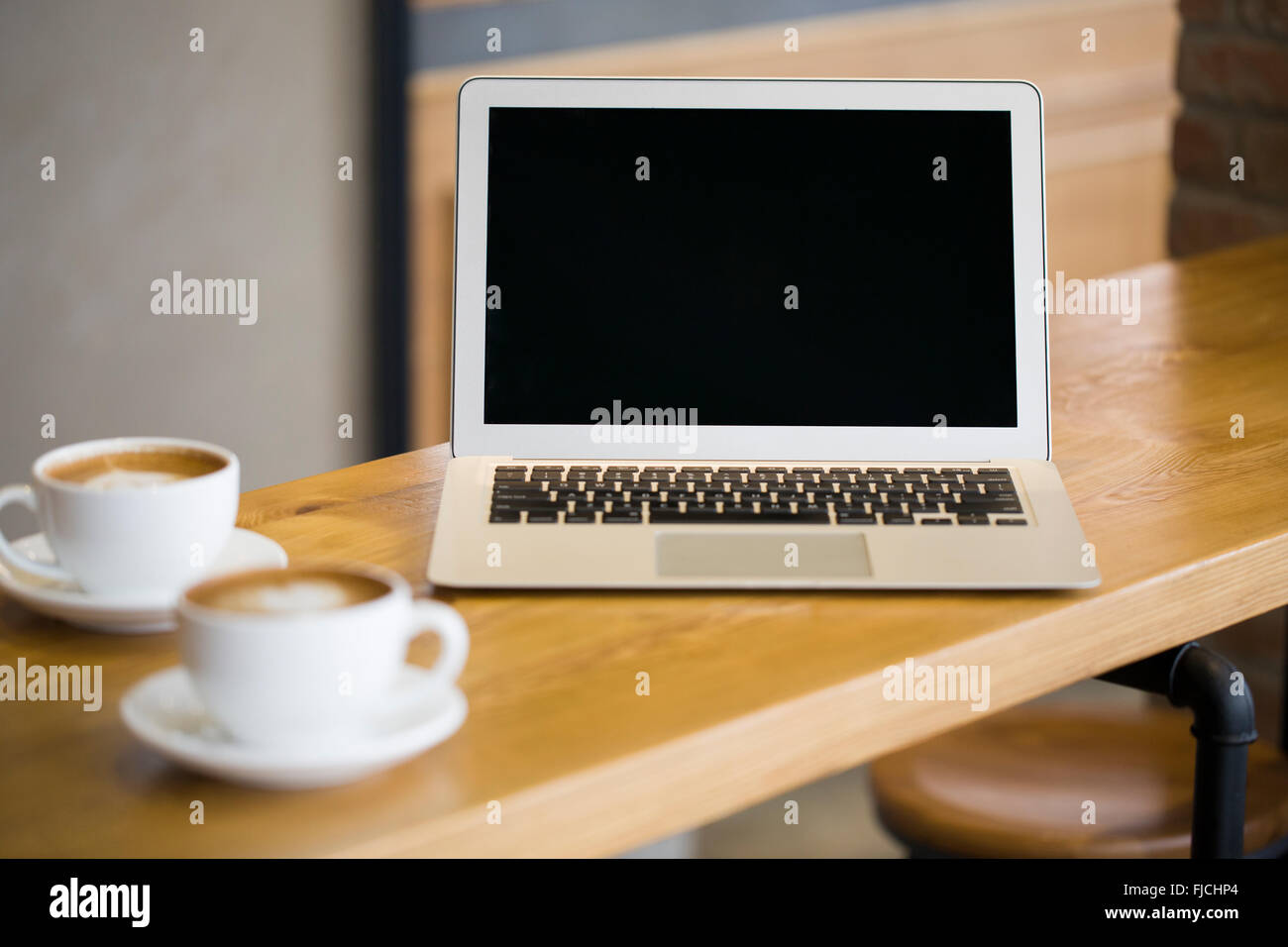 Coffee and laptop on the table Stock Photo - Alamy