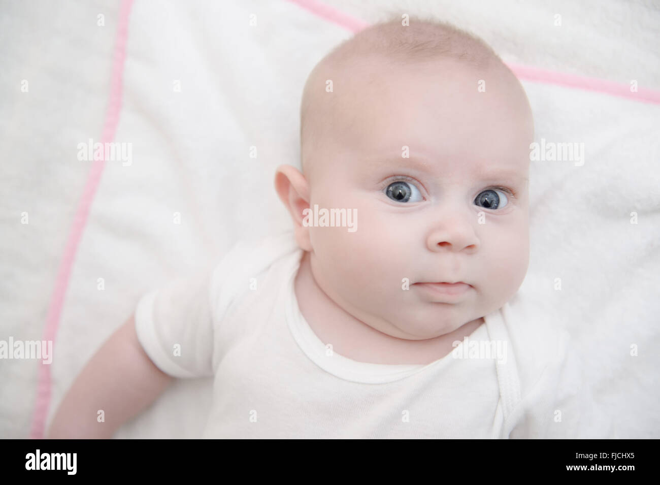 Baby girl posing with bright eyes, baby is newborn and very little ...