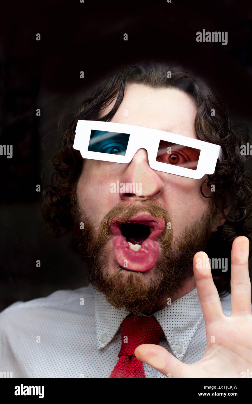 Silly bearded man wearing 3D glasses smooshing face against glass Stock ...