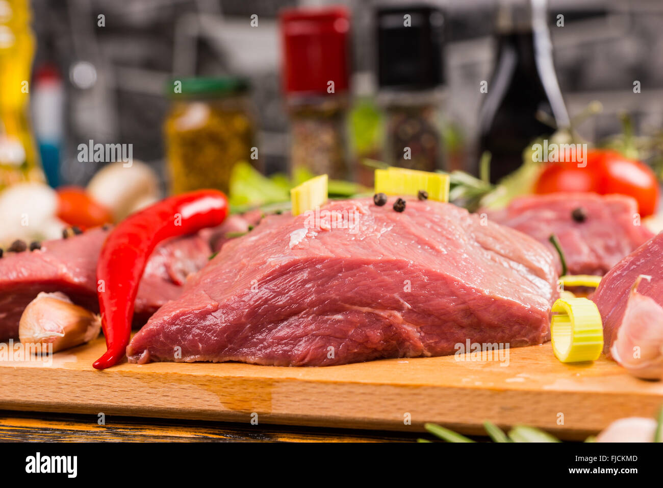 Big piece of red raw meat ready to be tenderized and cooked with ...