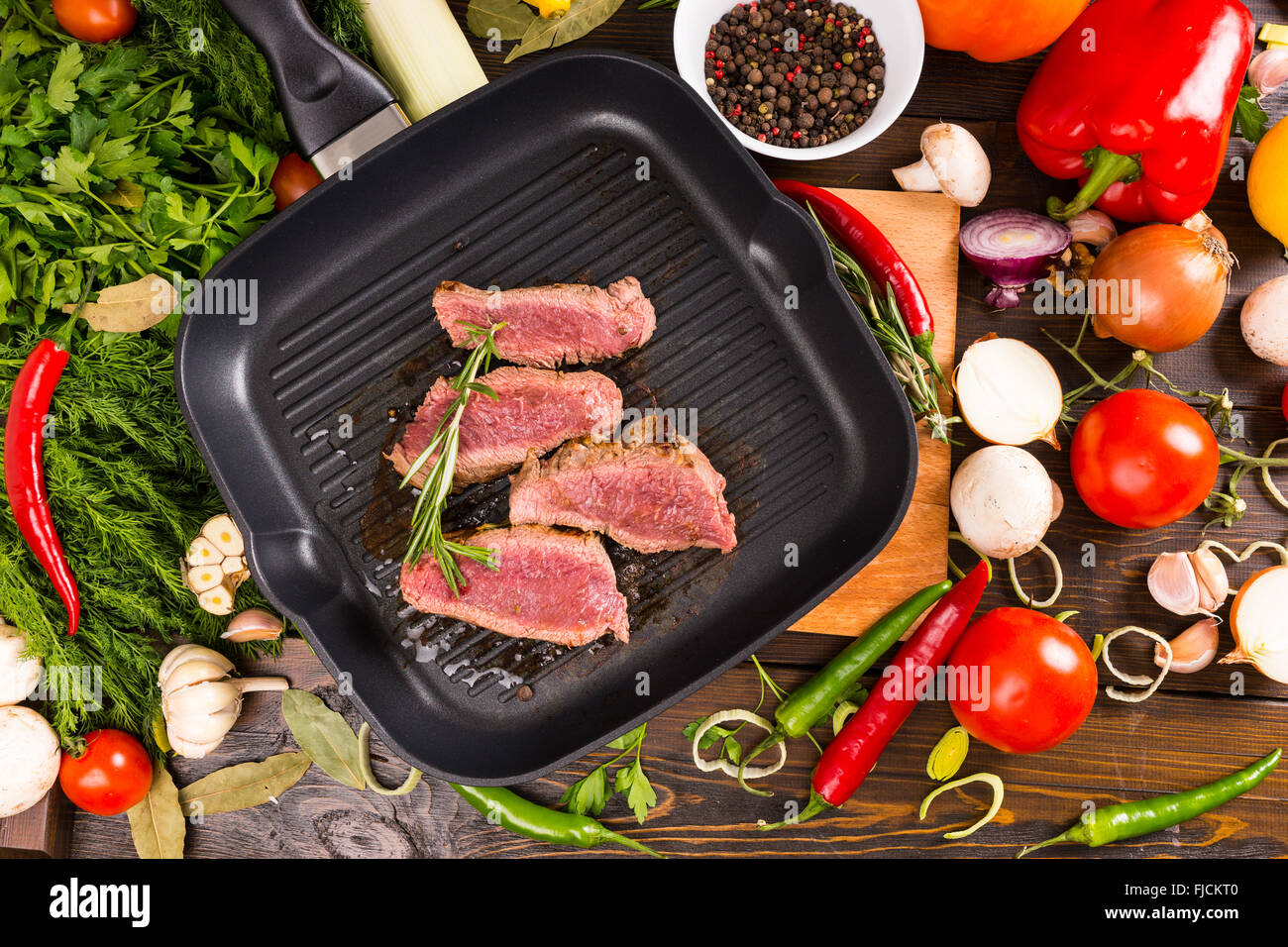 High Angle View of Rare Seasoned Sliced Beef Sizzling in Hot Frying Pan ...