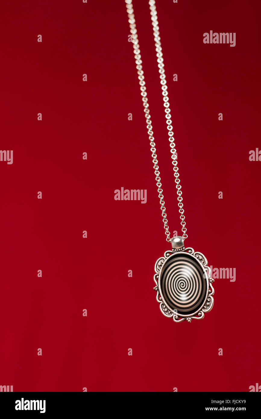 Hypnosis treatment tool swinging back and forth Stock Photo - Alamy