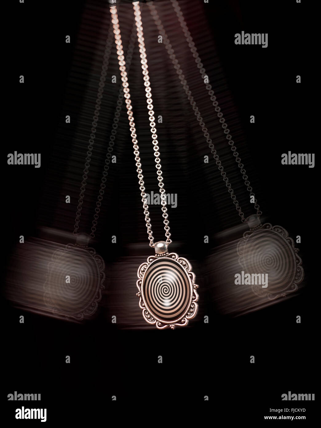 Hypnosis treatment tool swinging back and forth Stock Photo - Alamy