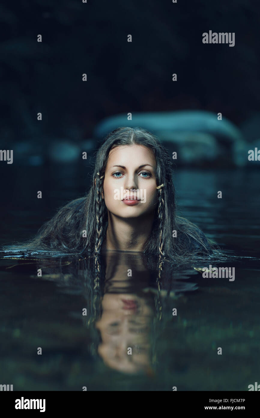 Beautiful water nymph in dark cyan stream . Ethereal and fantasy Stock ...