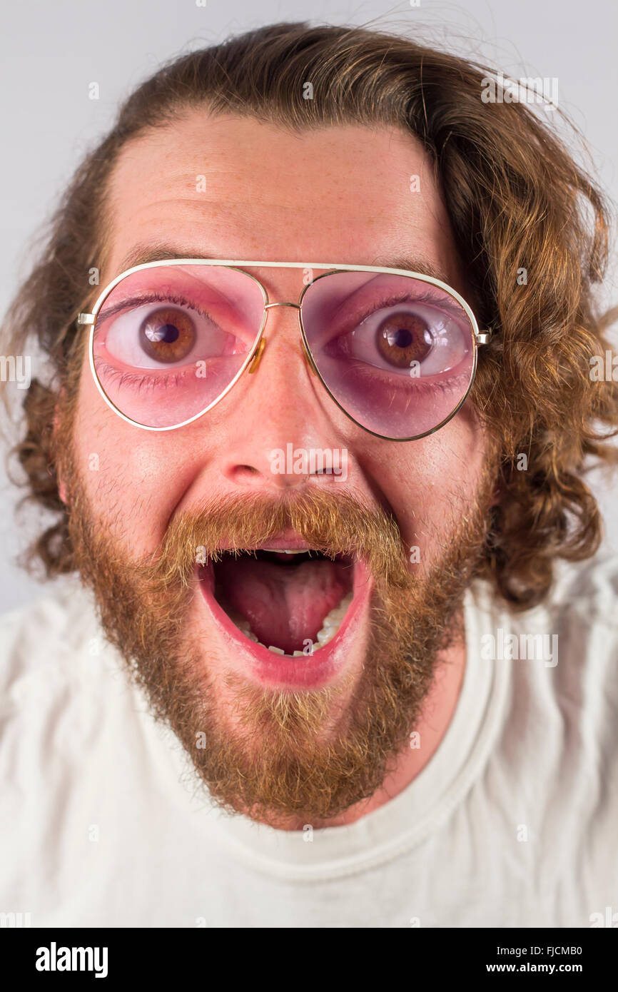 Silly surprised four eyed man wearing glasses Stock Photo - Alamy