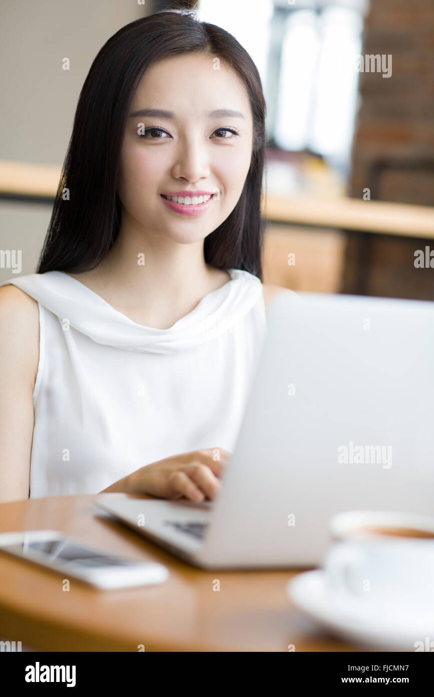 Young Chinese woman working with laptop in café Stock Photo - Alamy