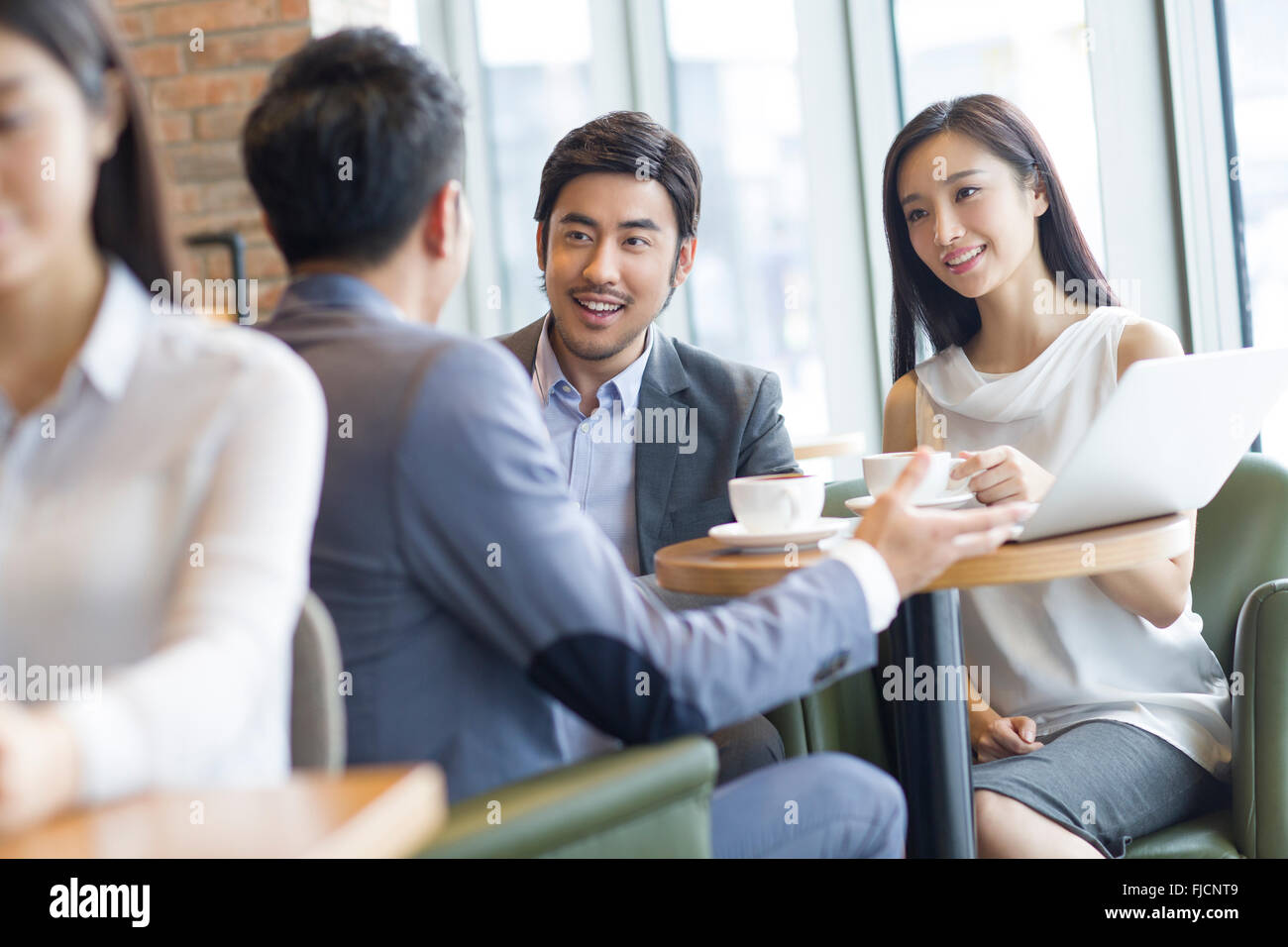Chinese businesspeople talking in café Stock Photo - Alamy