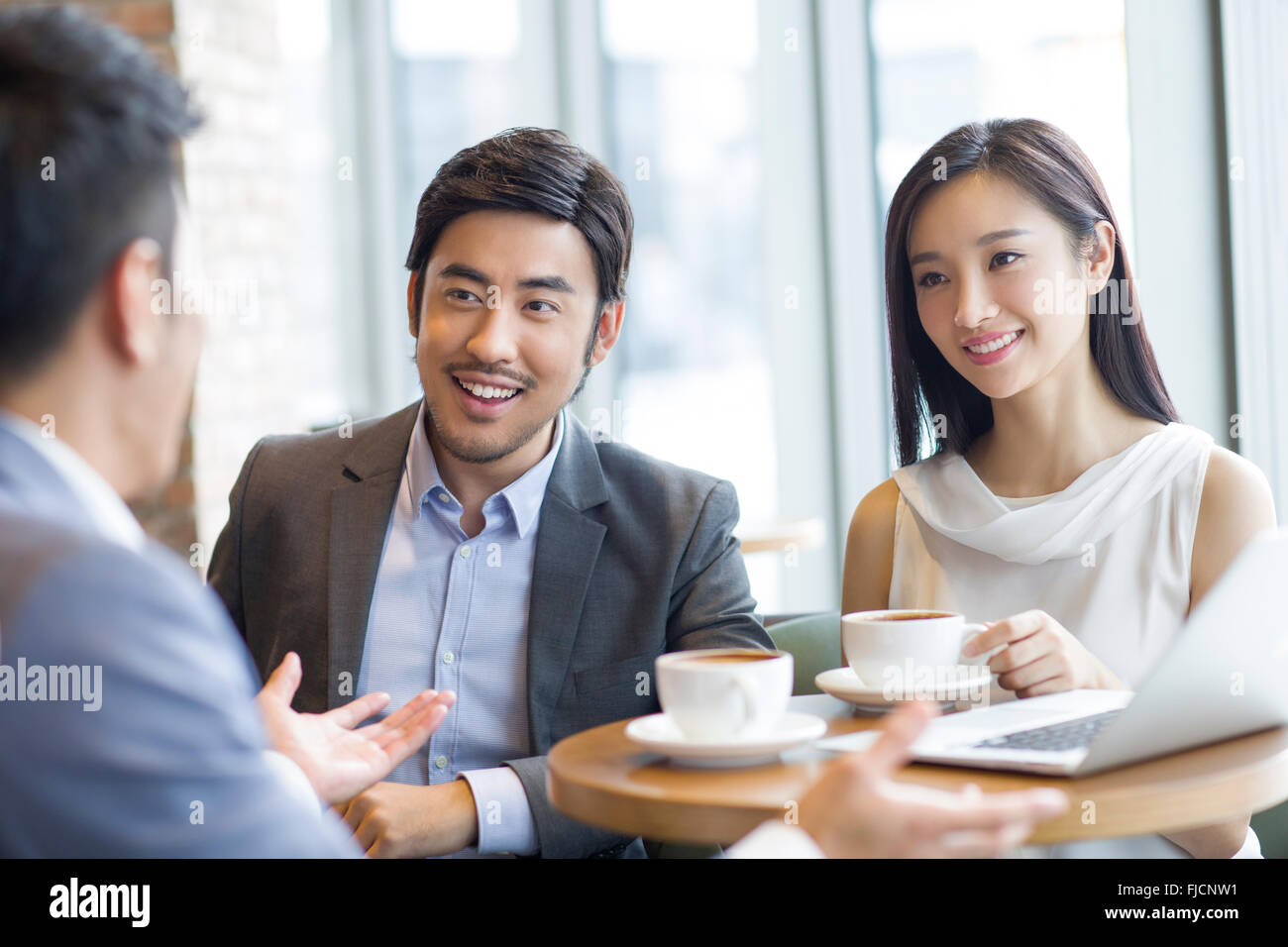 Chinese businesspeople talking in café Stock Photo - Alamy