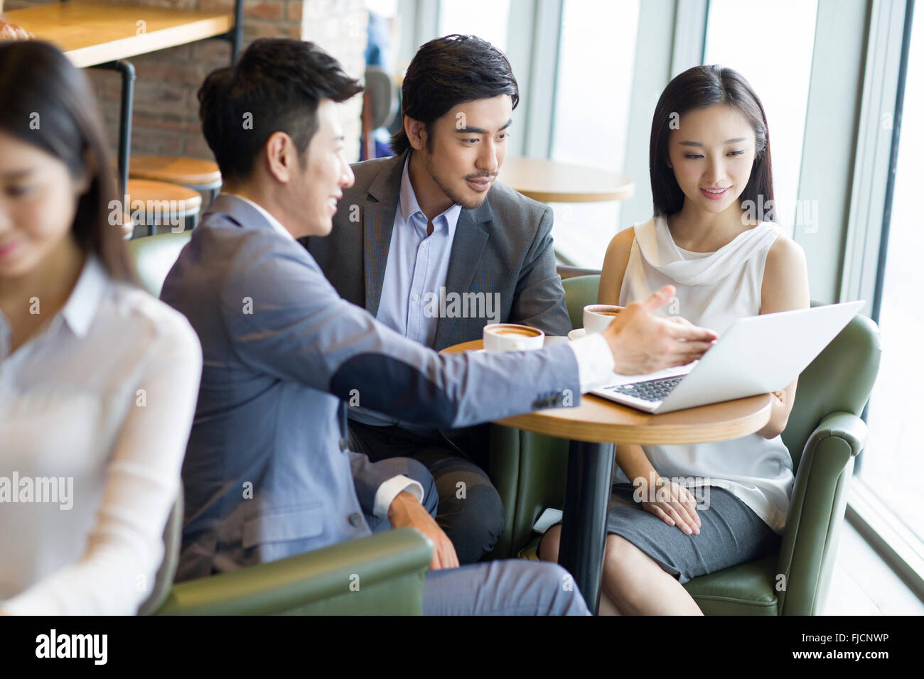 Chinese businesspeople talking in café Stock Photo - Alamy