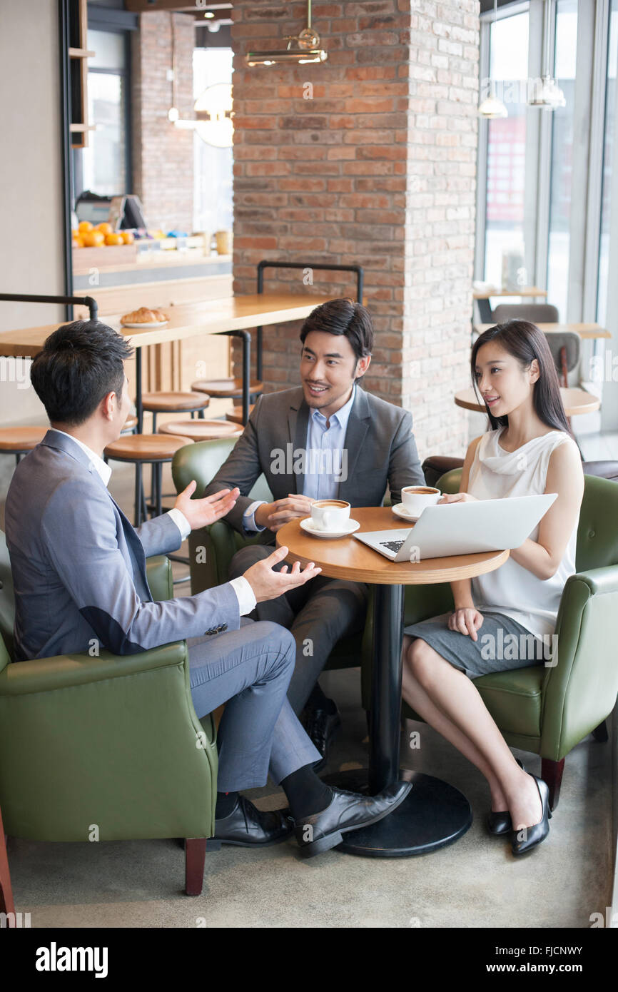 Chinese businesspeople talking in café Stock Photo - Alamy