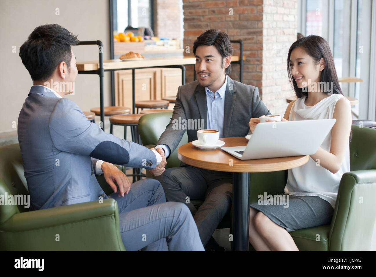 Chinese businesspeople talking in café Stock Photo - Alamy