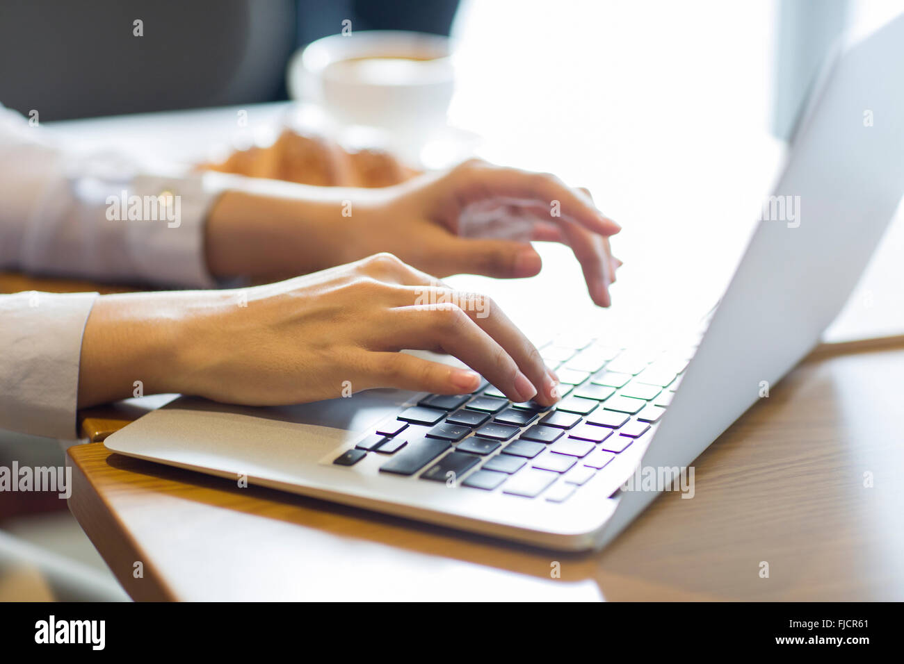 Young Chinese woman working with laptop in café Stock Photo - Alamy