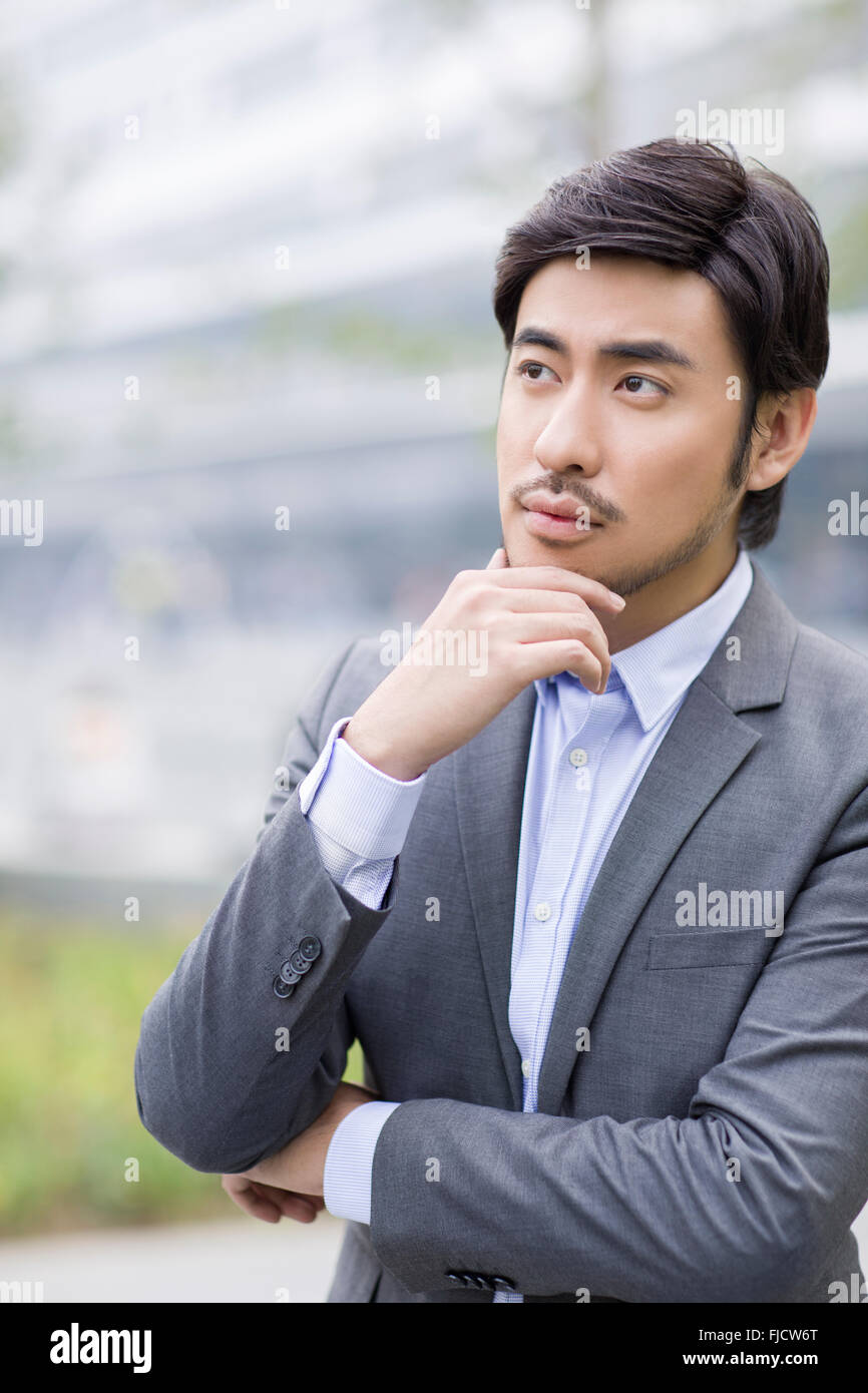 Chinese businessman thinking Stock Photo - Alamy