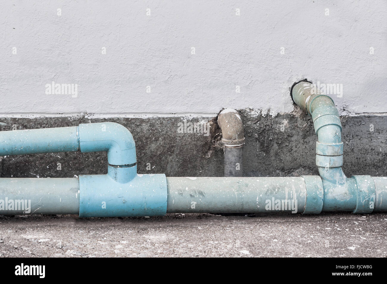old waste water pipe on wall background Stock Photo - Alamy