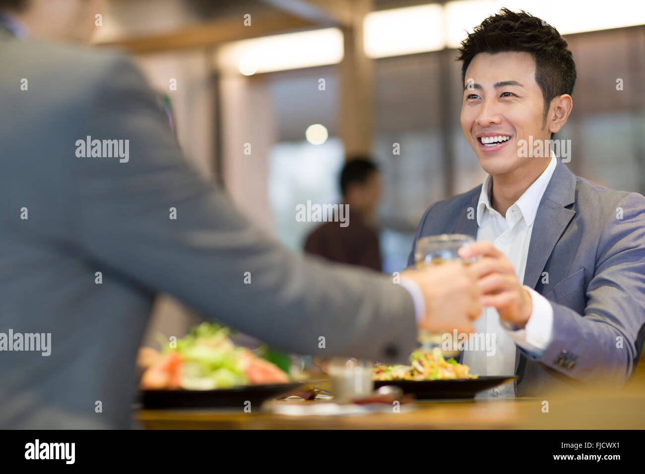 Chinese businessmen having dinner together Stock Photo - Alamy