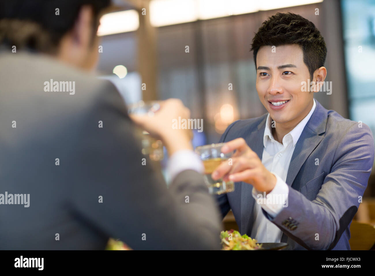 Chinese businessmen having dinner together Stock Photo - Alamy