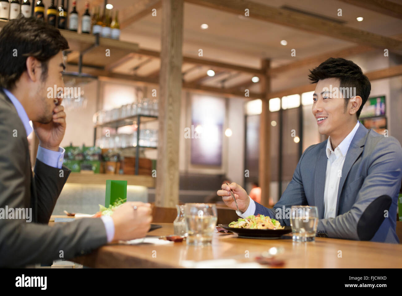 Chinese businessmen having dinner together Stock Photo - Alamy