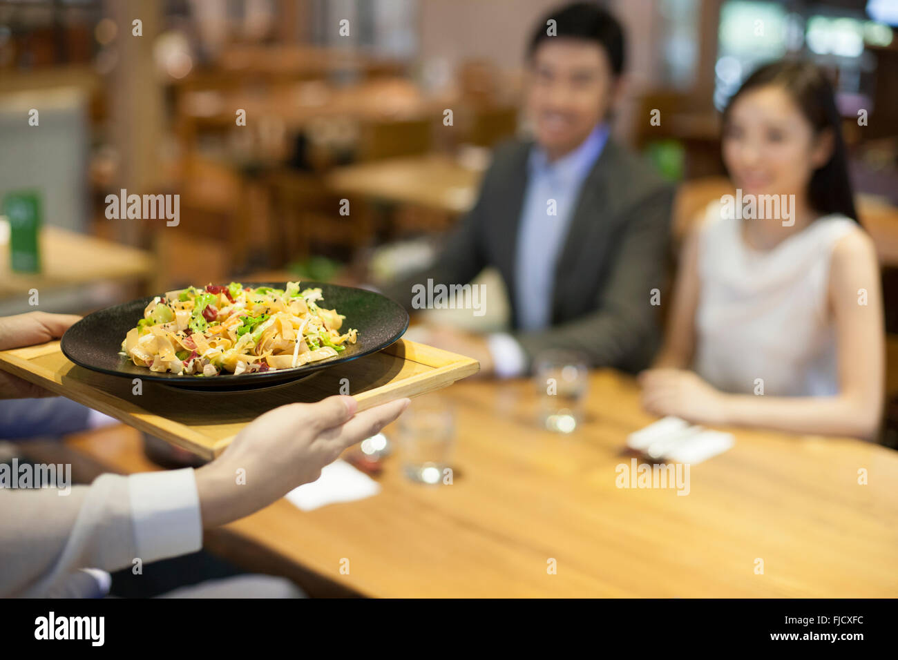 Chinese waitress serving in restaurant Stock Photo - Alamy